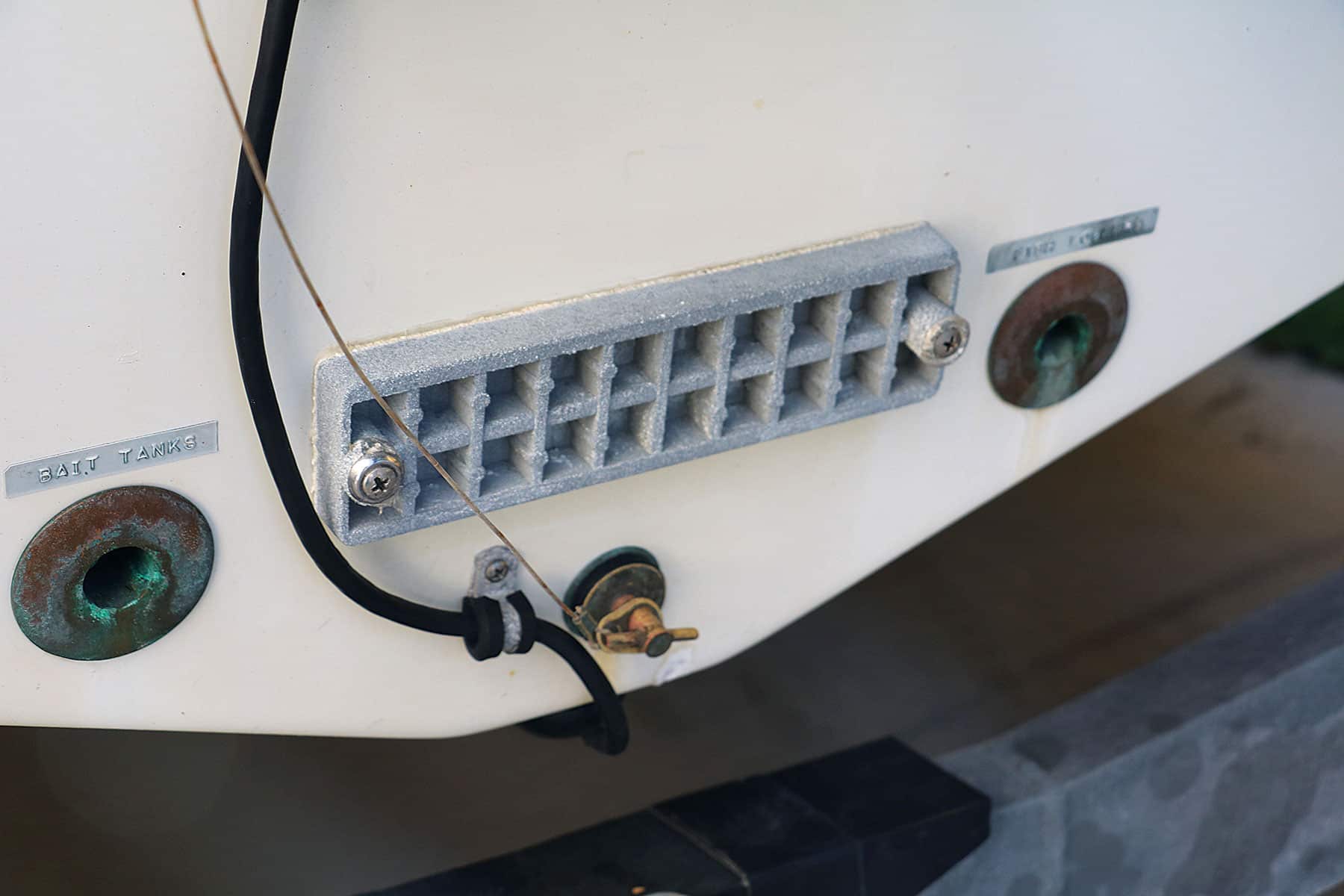 Secure Drain Plug Near Drain Hole on Boat | Sport Fishing Mag